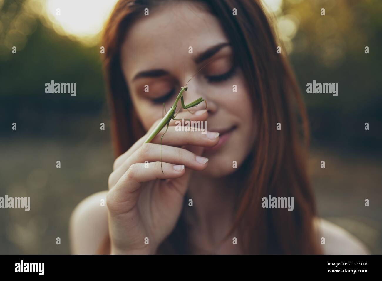 woman in white dress with a praying mantis in hand animals Stock Photo ...