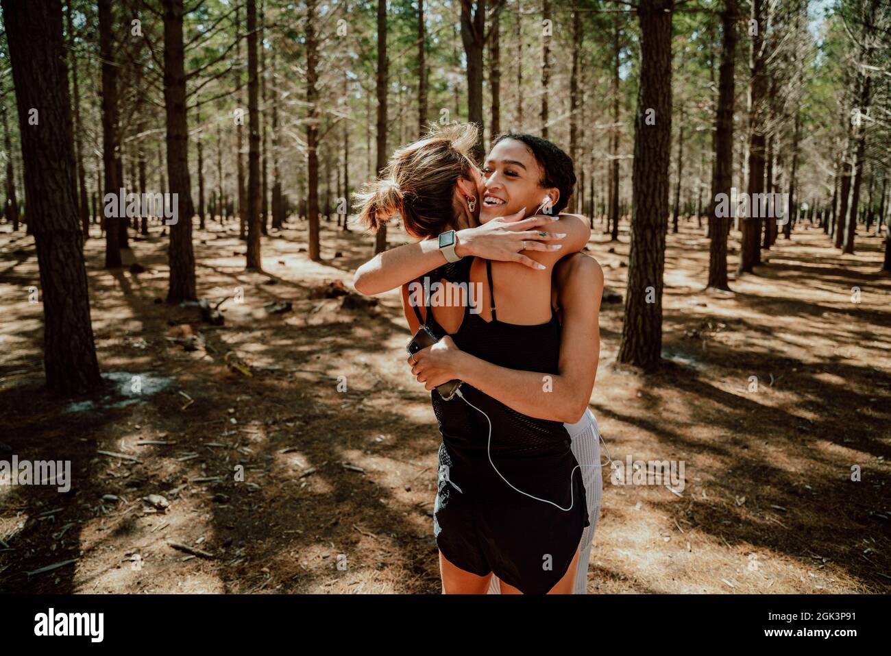 Two friends hugging in forest enjoying nature together Stock Photo - Alamy