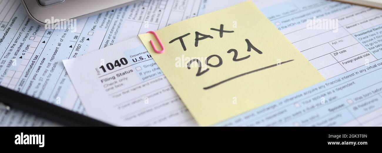 Tax form for 2021 and calculator with pen are on t table Stock Photo ...