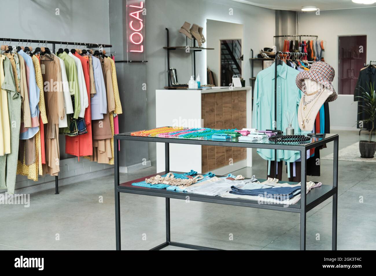 Image of clothing department with new clothes hanging on the racks and ...