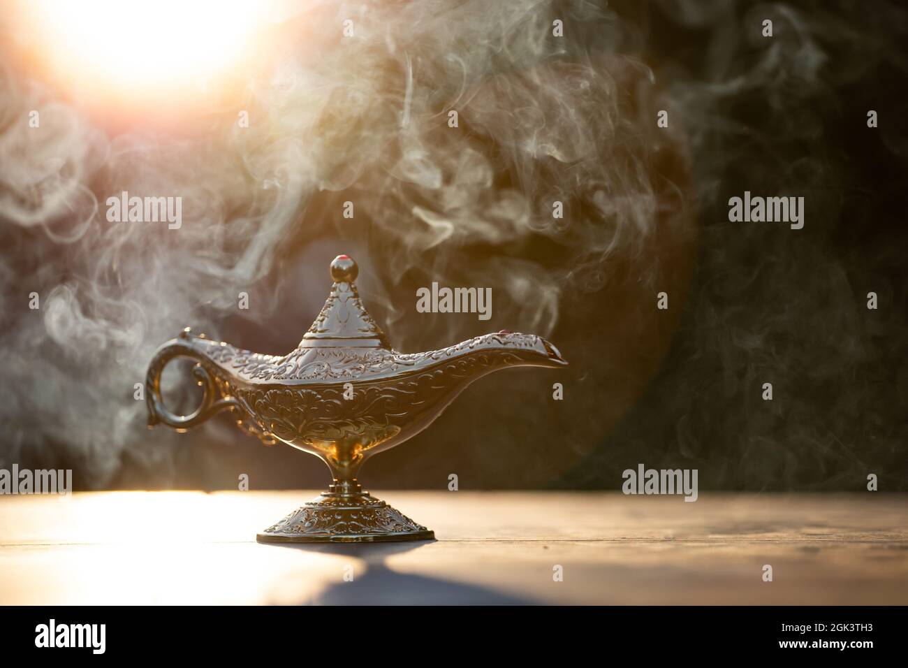 Magic lamp from the story of Aladdin in smoke. Concept for wishing ...