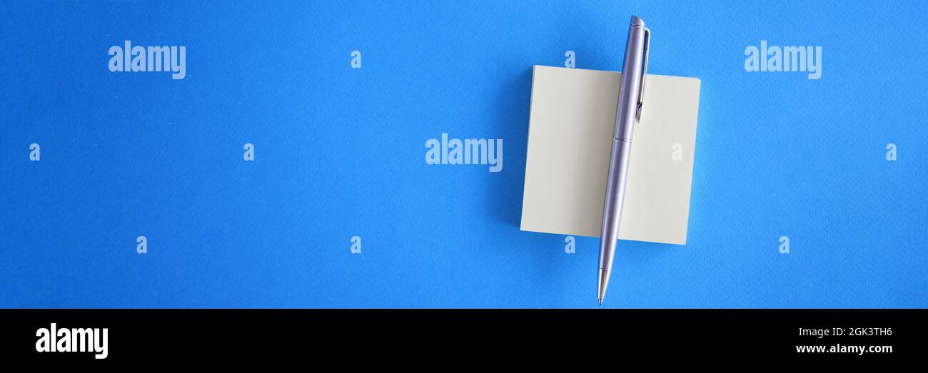 White sticky notes with pen on light blue background Stock Photo - Alamy