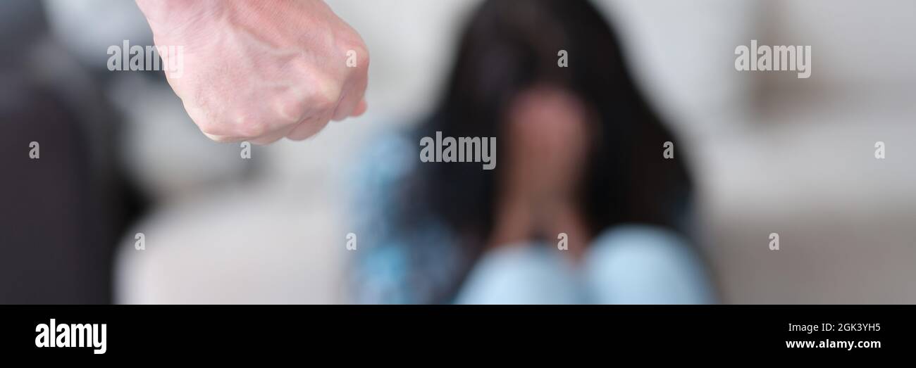Man stands with fist clenched against background of crying woman Stock ...