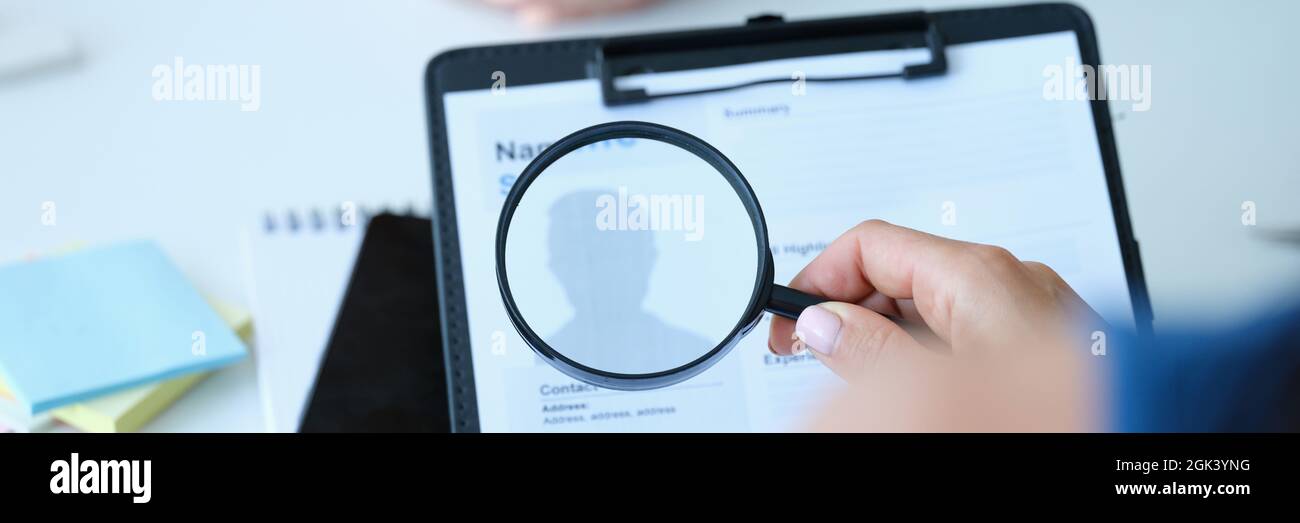 Employee examines resume application form under magnifying glass Stock ...