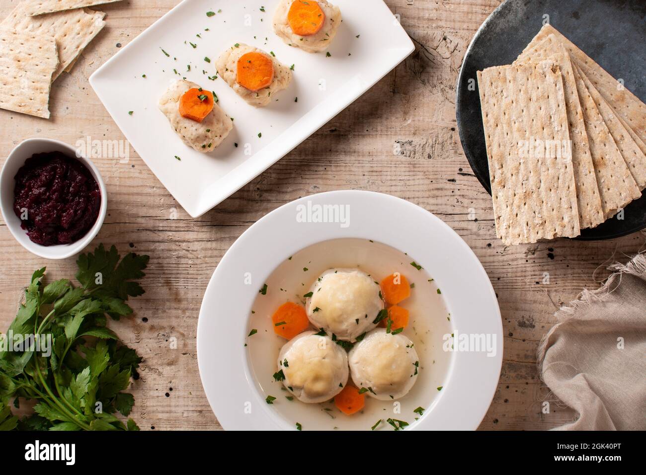 Traditional Jewish matzah ball soup, gefilte fish and matzah bread on ...