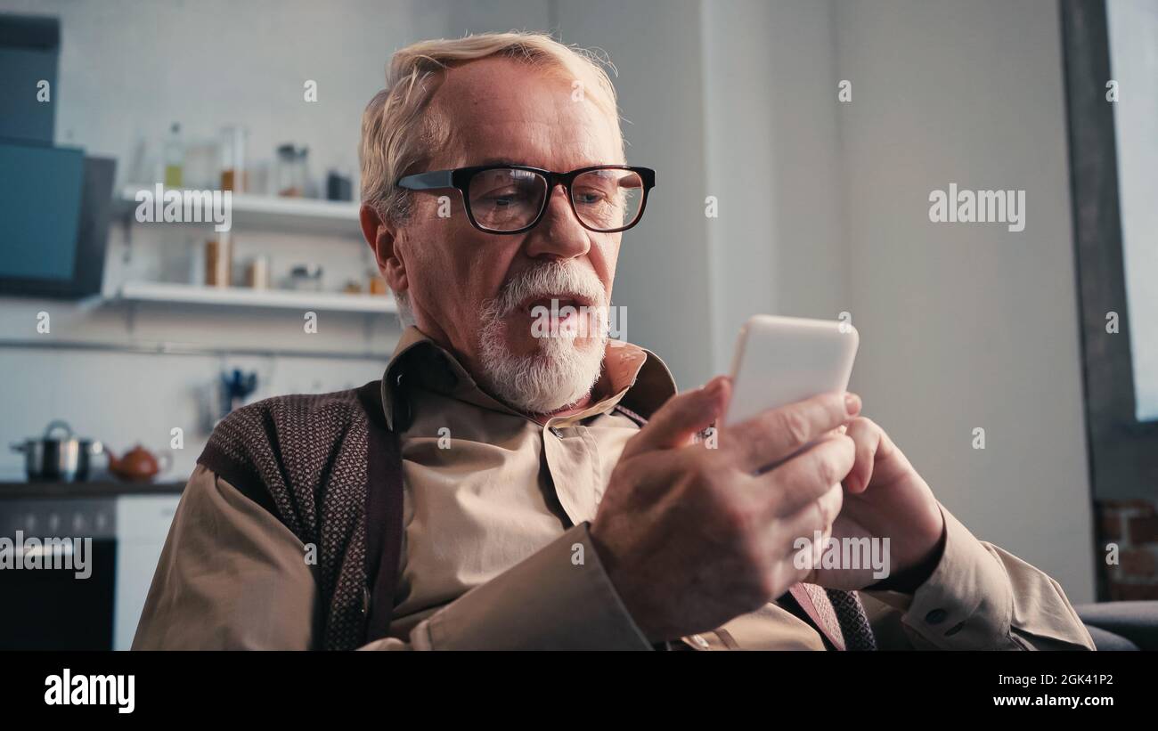 Retired man using smartphone device hi-res stock photography and images ...