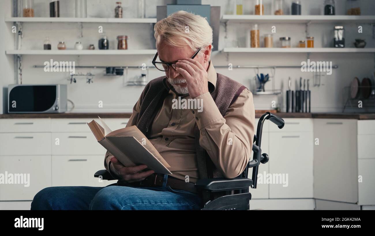 Disabled senior man reading book hi-res stock photography and images ...