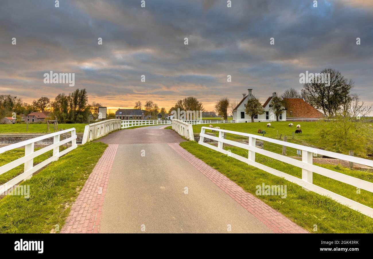 Dutch Countryside landscape with historical houses in evening along a ...