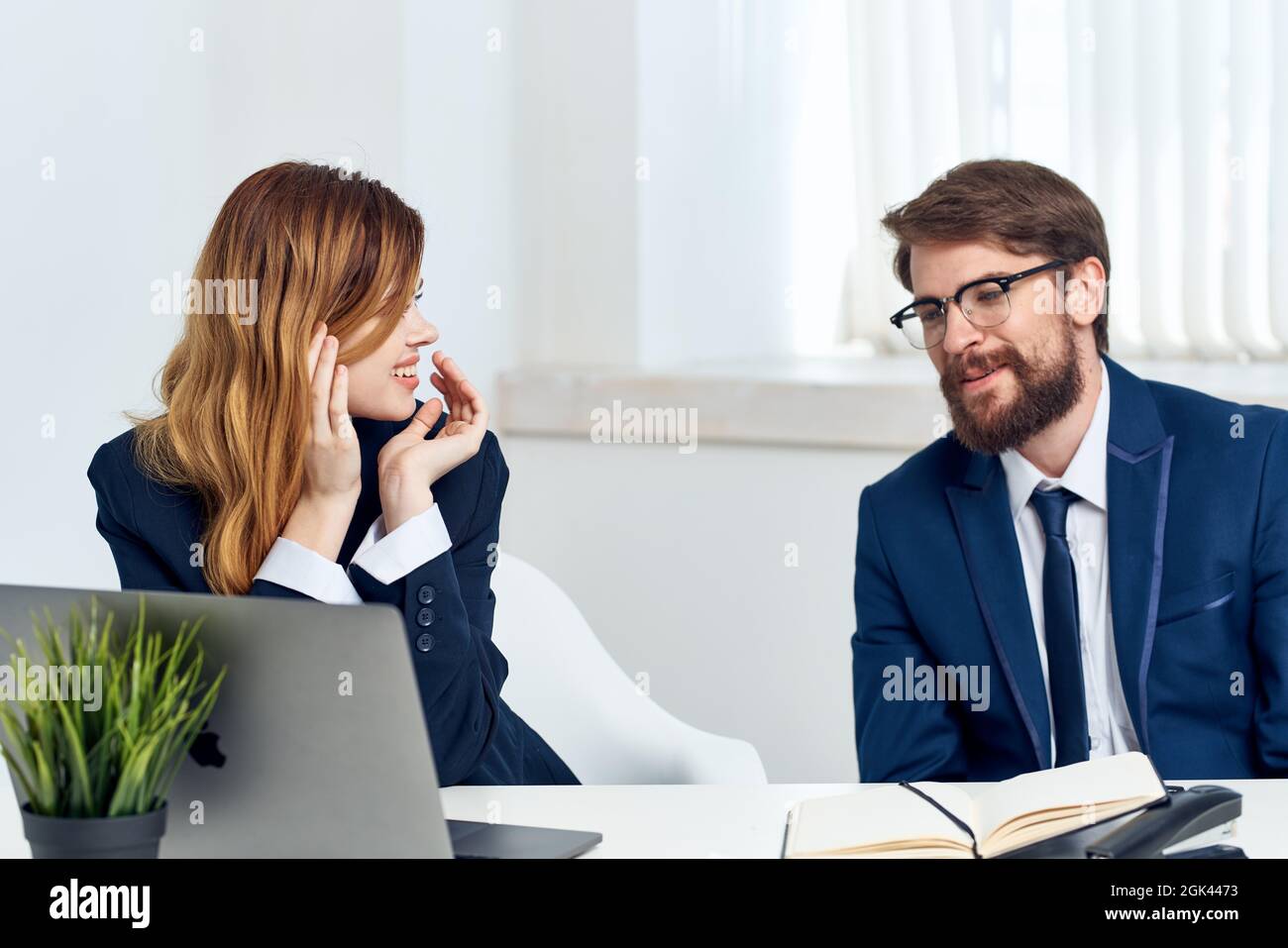 man and woman managers work together in front of laptop professionals ...
