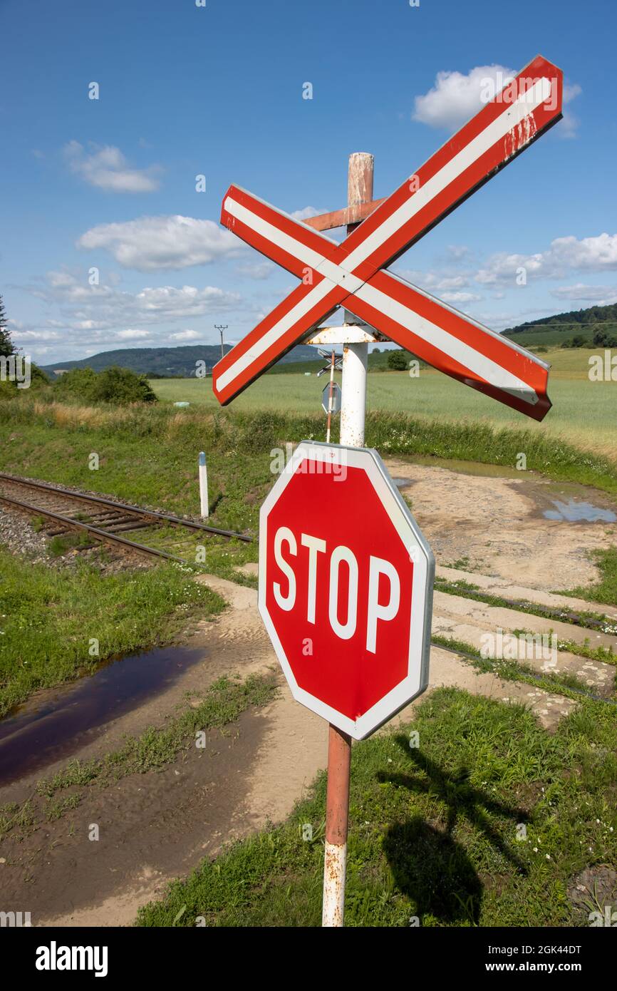 A red STOP sign before crossing the tracks Stock Photo - Alamy