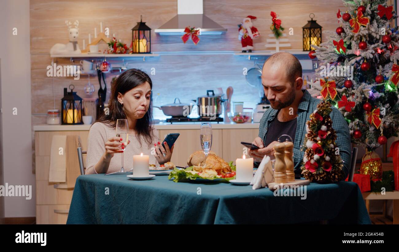 Family looking smartphones dinner table hi-res stock photography and ...