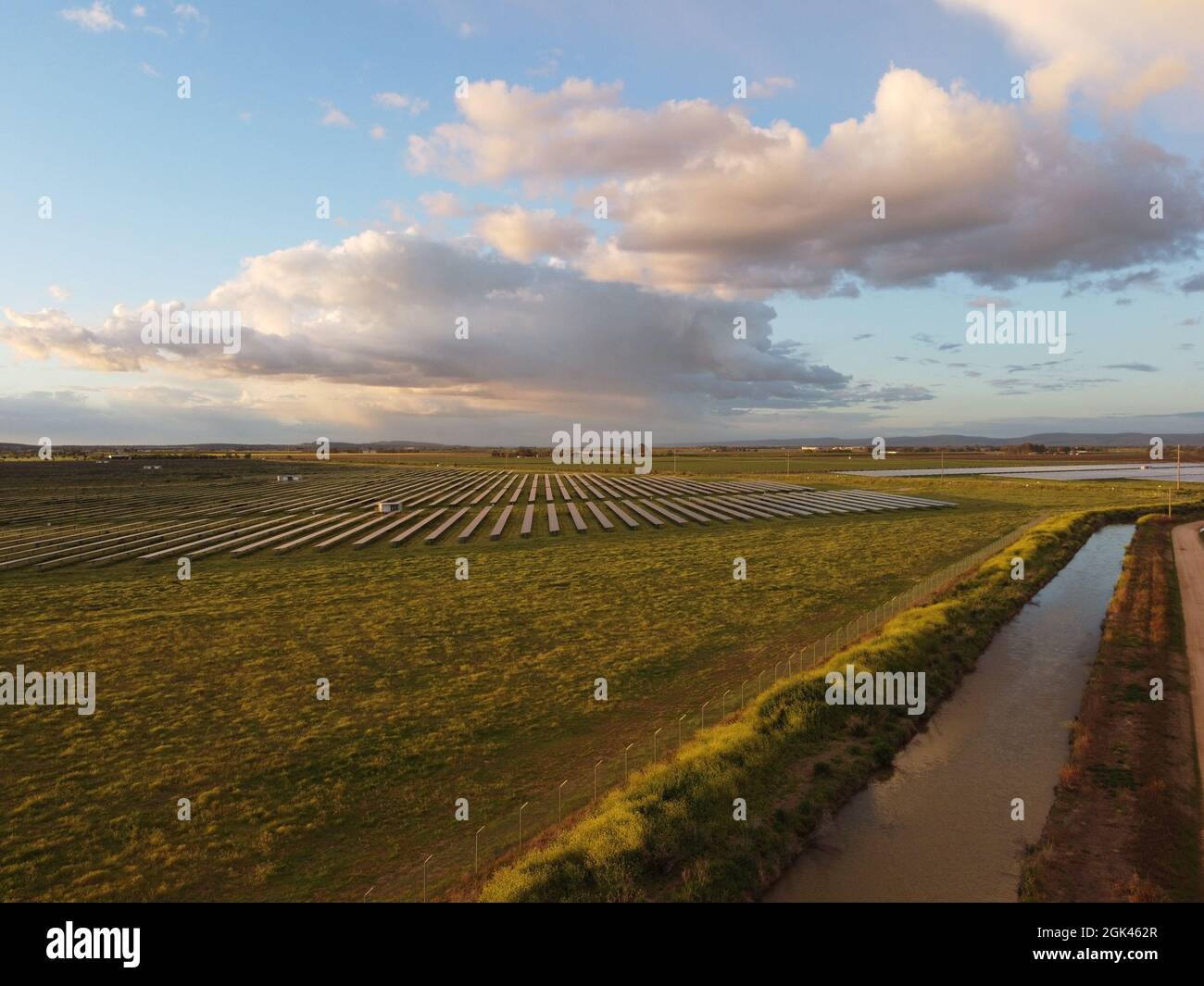 Irrigation channel in front of solar farm Stock Photo - Alamy