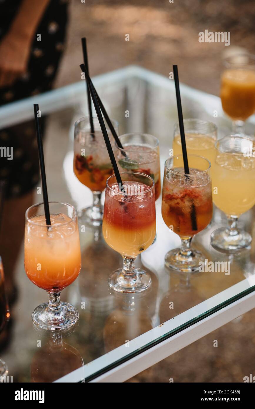 Vertical closeup of the cocktails on the glass table Stock Photo - Alamy