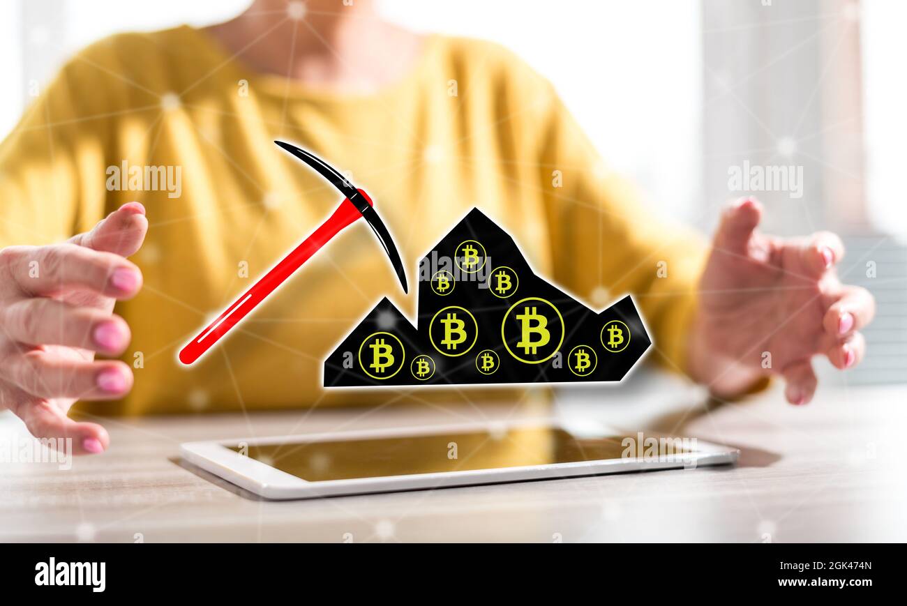 Digital tablet with bitcoin mining concept between hands of a woman in ...