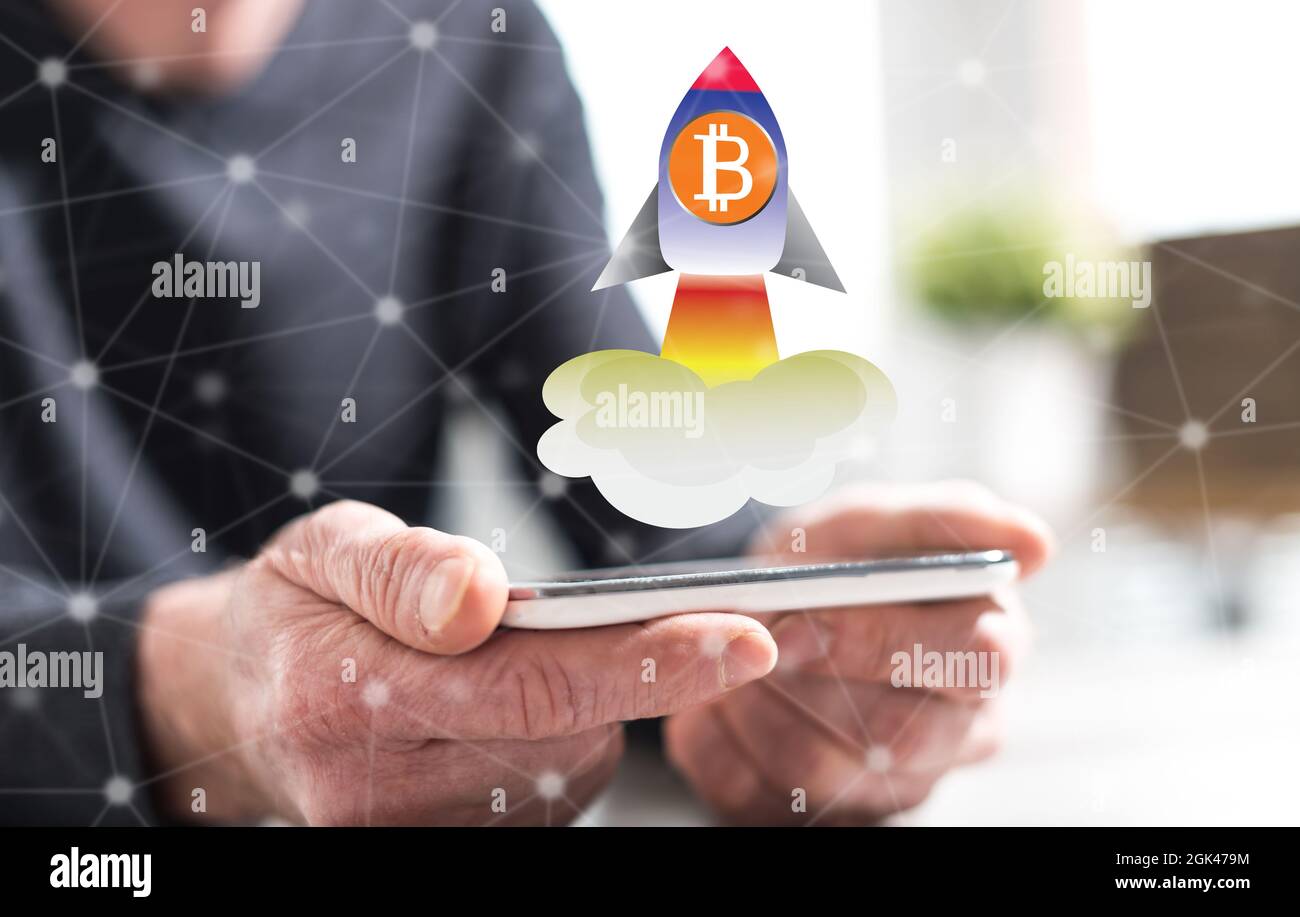Hands of man holding a smartphone with bitcoin rise concept Stock Photo ...
