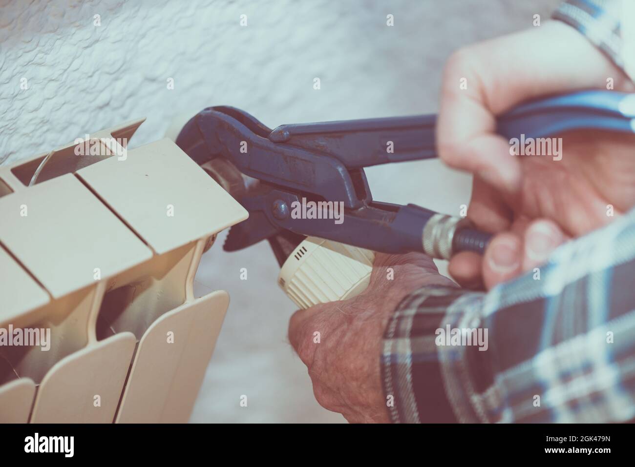 Repairman hands working on radiator with wrench Stock Photo - Alamy