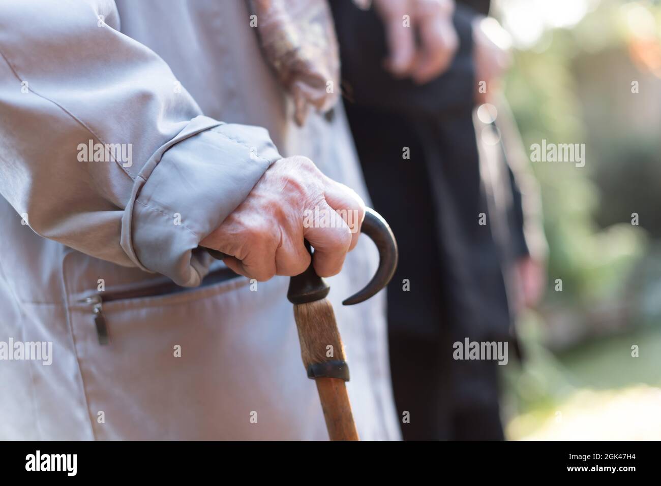 Senior woman walking with a cane Stock Photo - Alamy