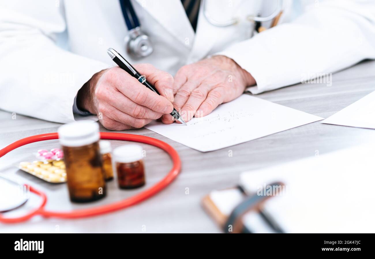 Doctor writing a medical prescription in office Stock Photo - Alamy