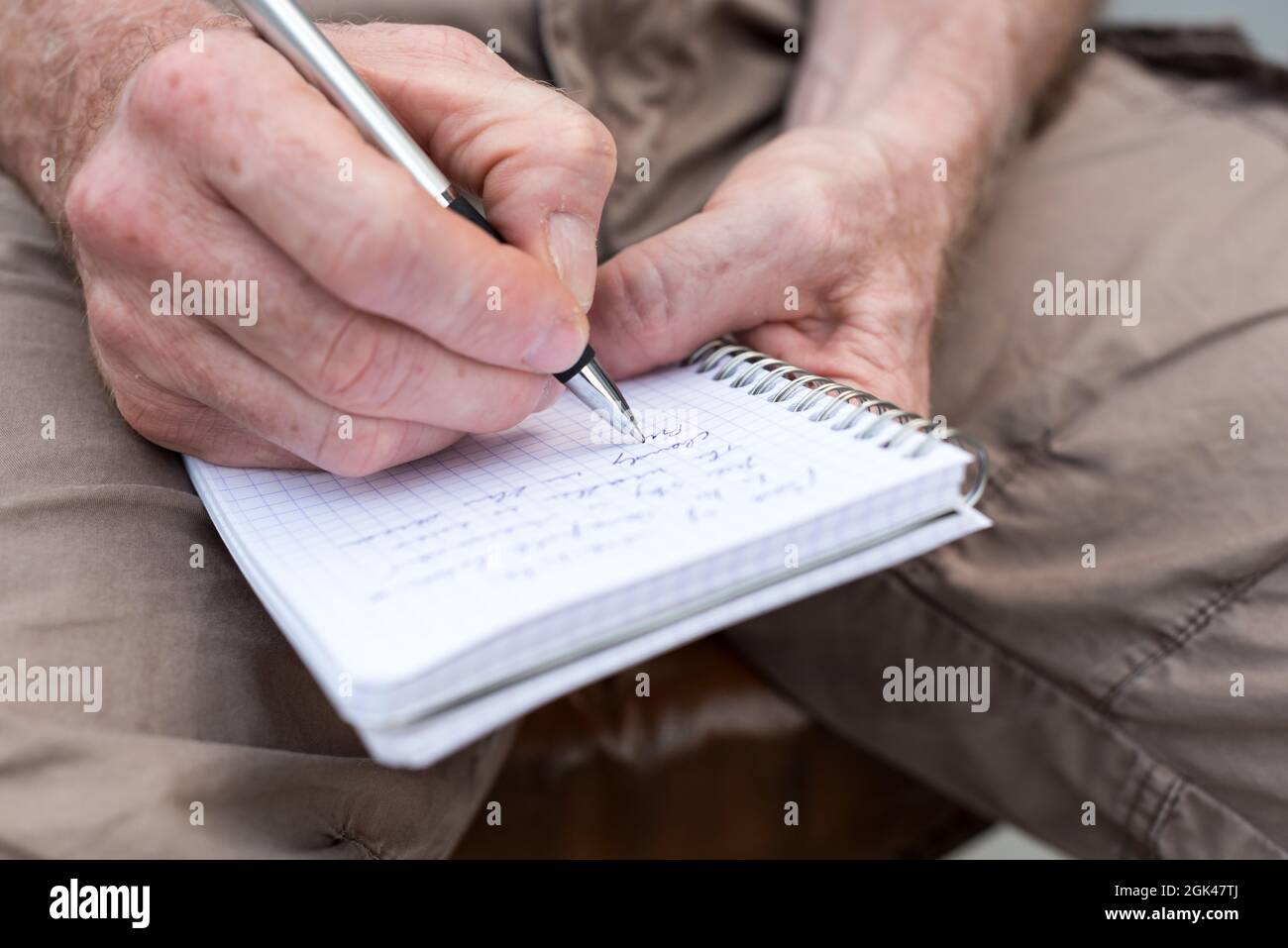 Man taking notes on a pocket book, closeup Stock Photo - Alamy