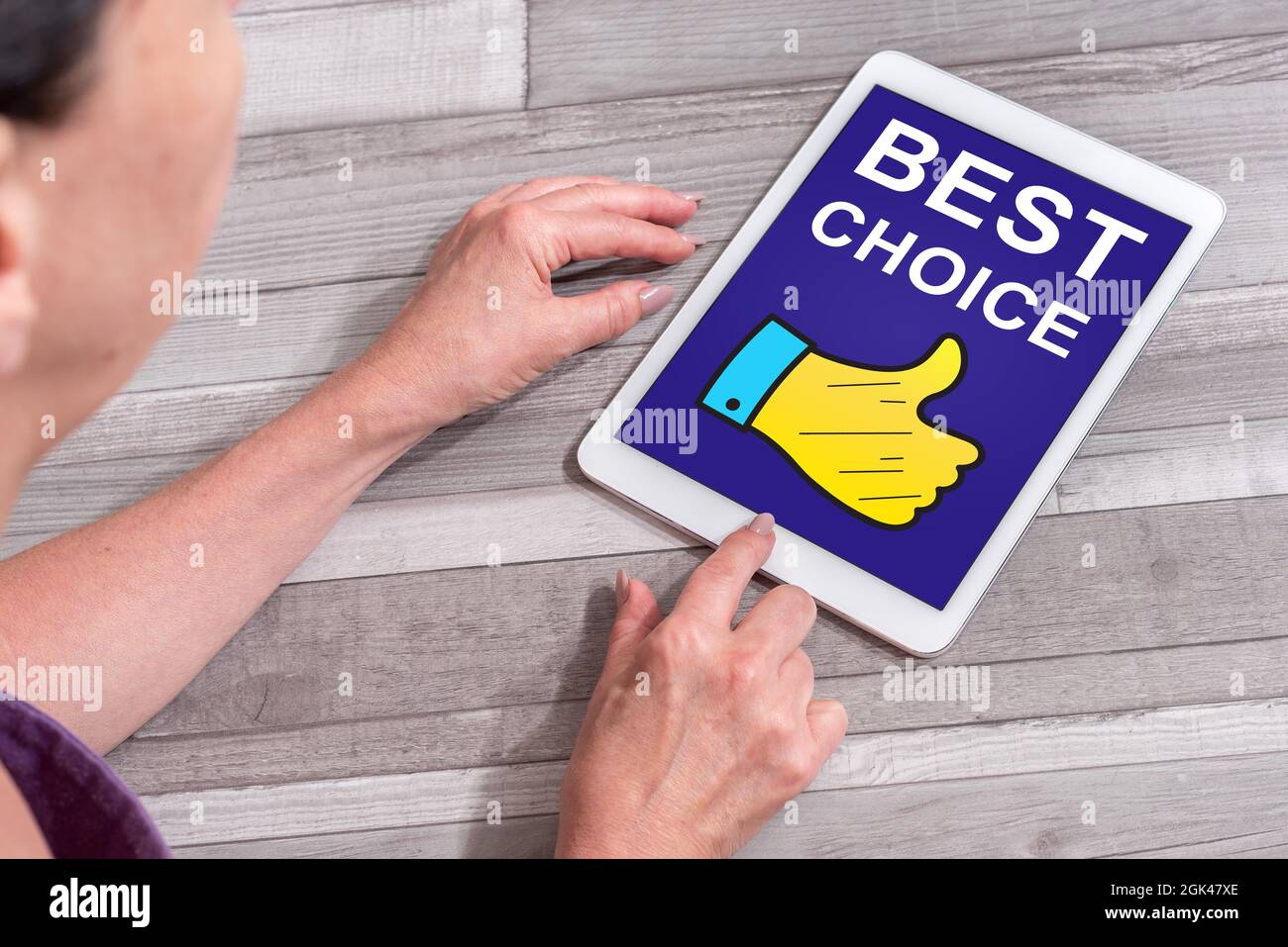 Woman using a tablet showing best choice concept Stock Photo - Alamy