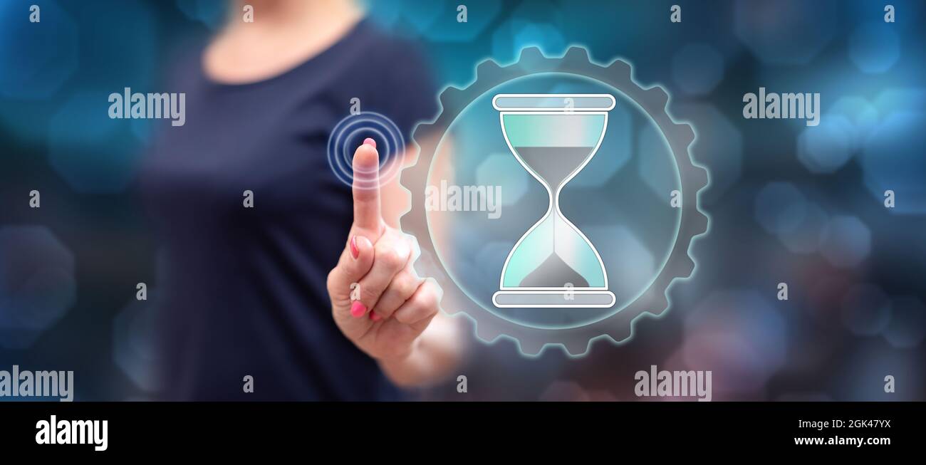 Woman touching a time management concept on a touch screen with her ...