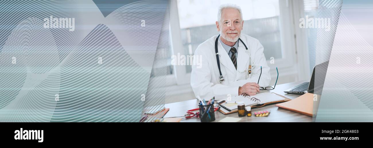 Portrait of male senior doctor sitting in medical office; panoramic ...