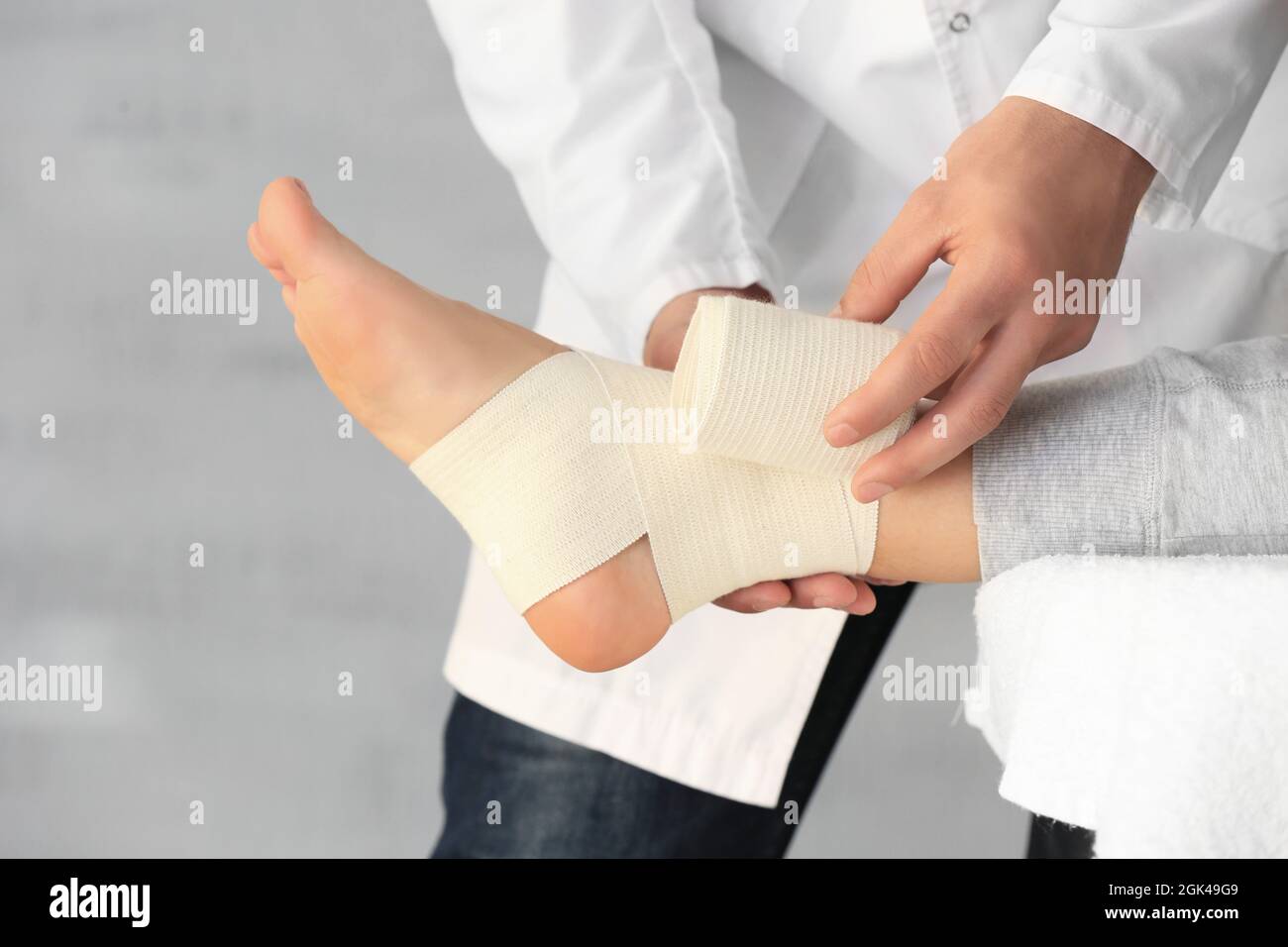 Doctor applying bandage onto patient's leg in clinic, closeup Stock ...