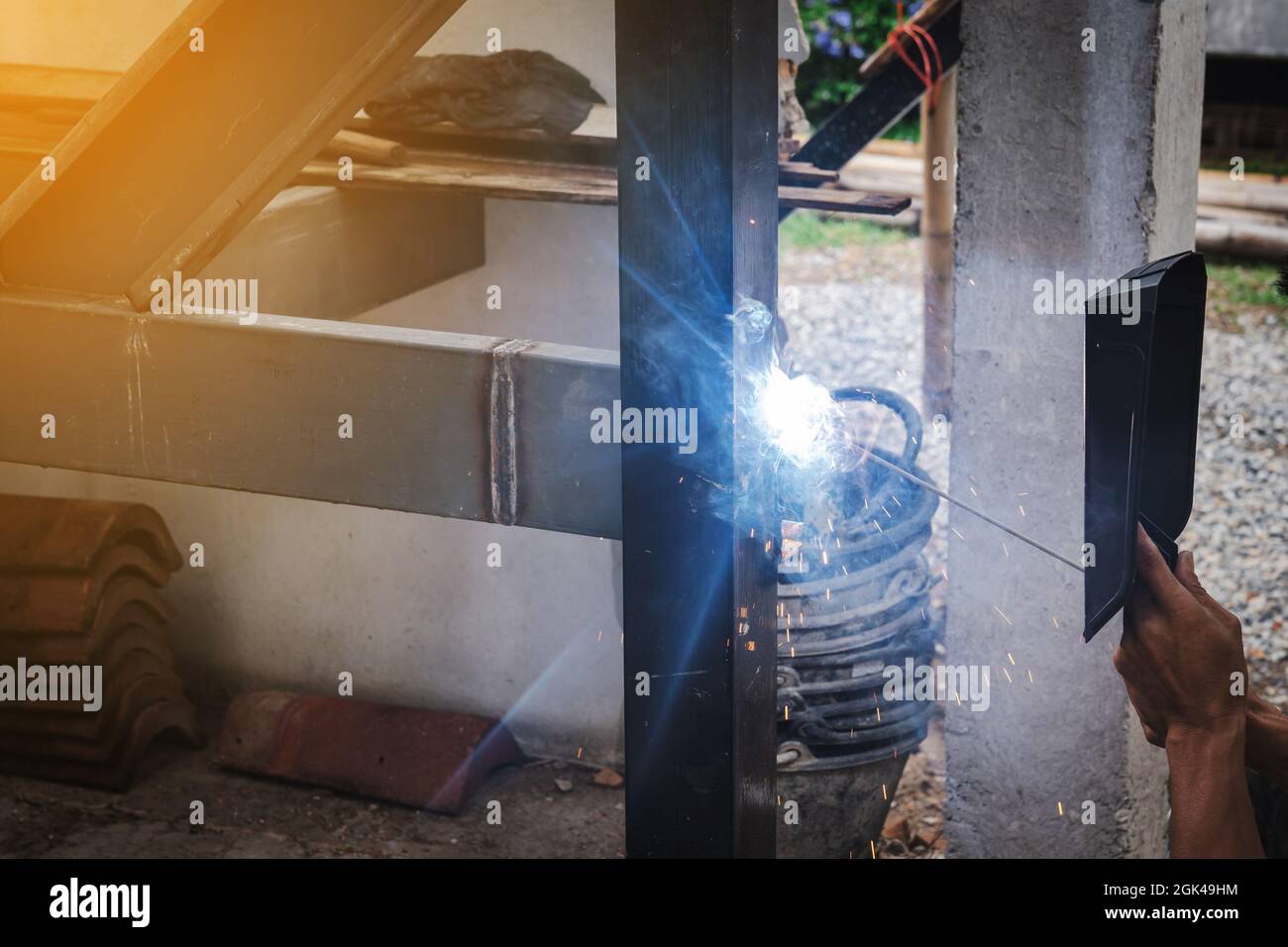 Man welder doing a metal staircase structure in a residential building ...