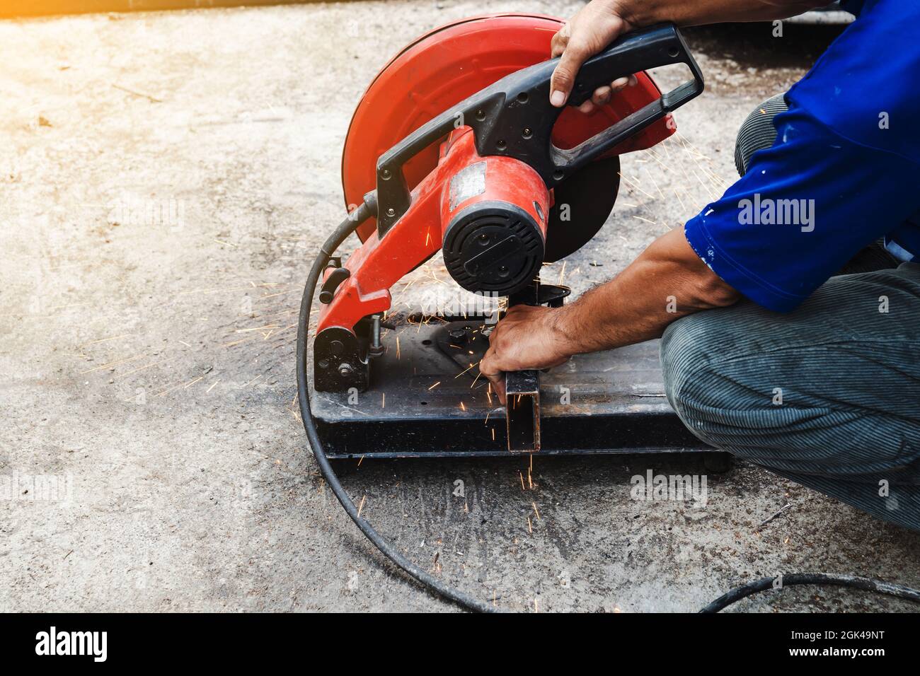 Worker man cutting steel with a circular steel cutter Stock Photo - Alamy