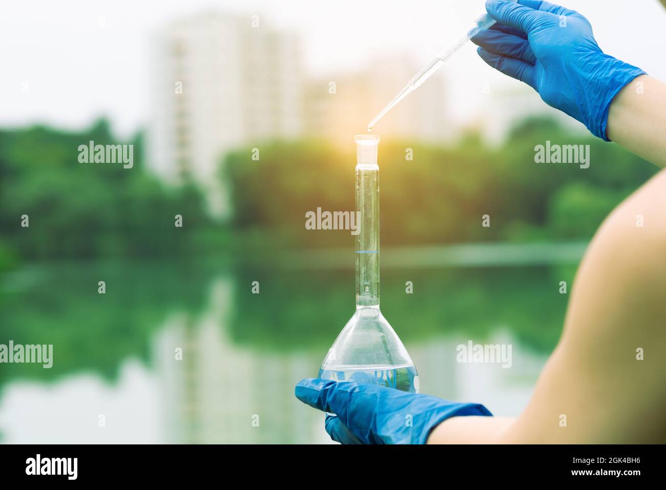 Sampling from open water. A scientist or biologist takes a sample of ...