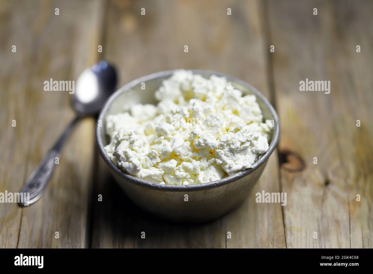 Fresh cottage cheese in an iron bowl. Rustic style Stock Photo - Alamy