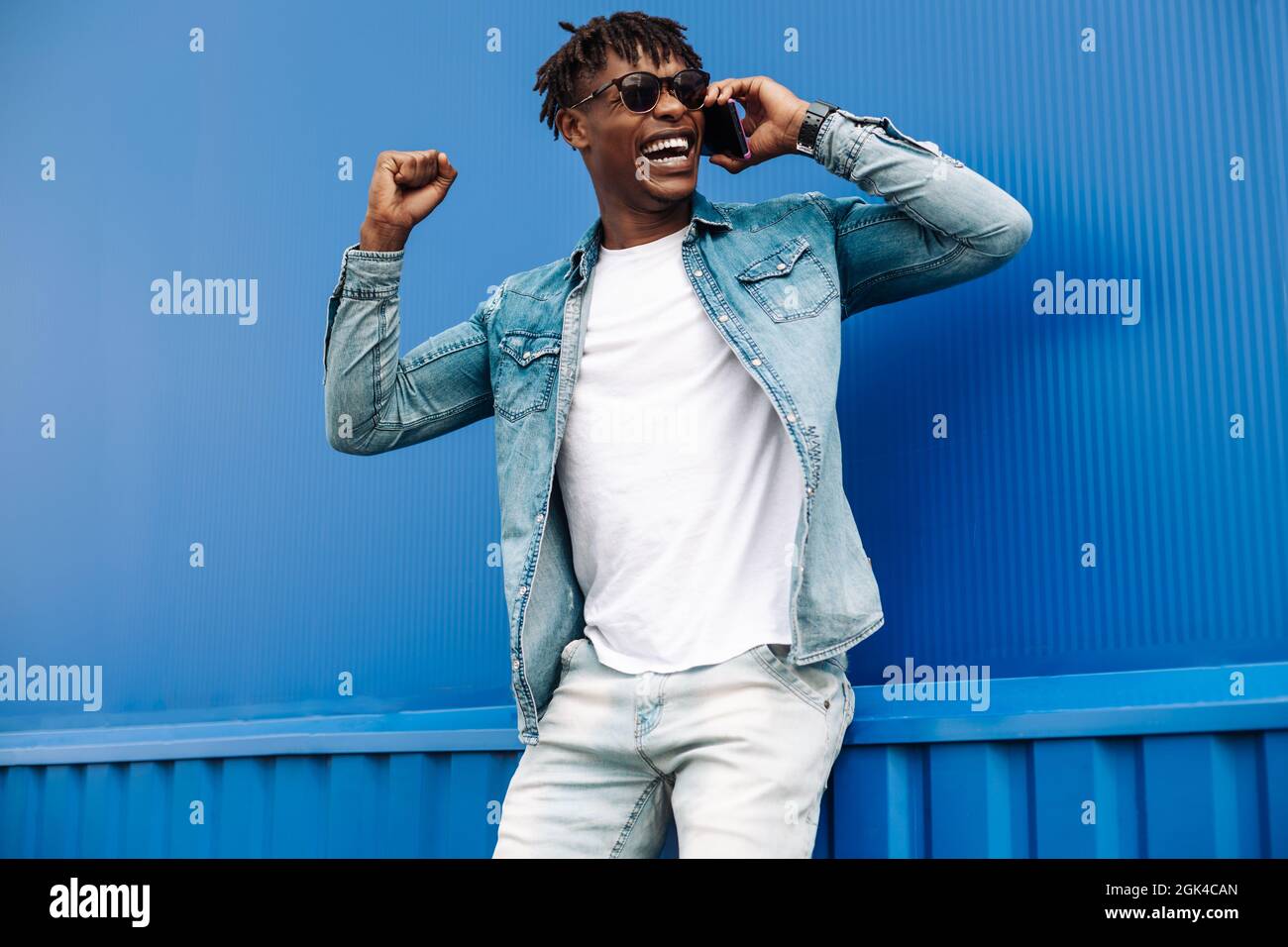 successful american black guy calls on the phone, shows a sign of ...