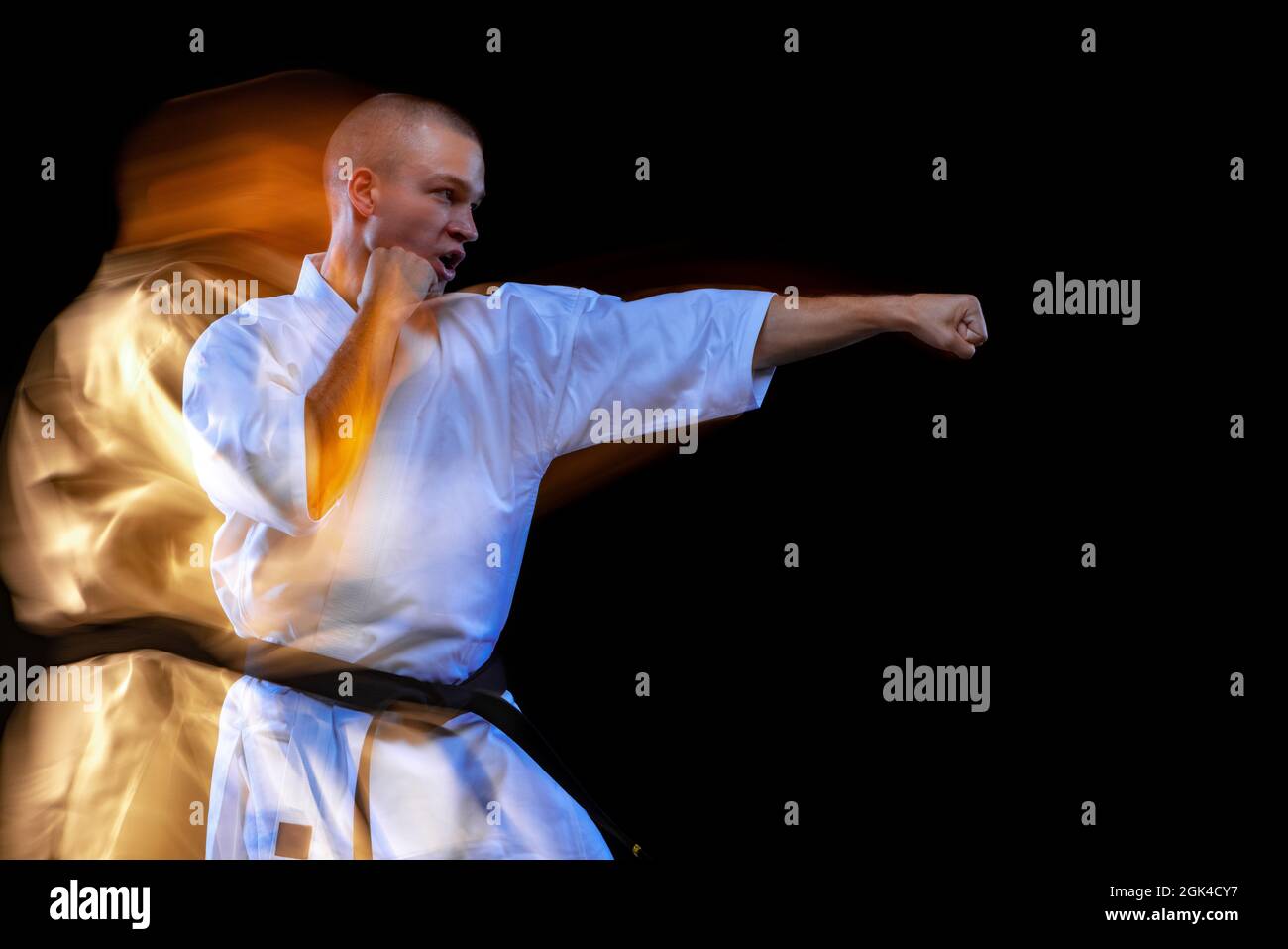 Cropped portrait of young karate sportsman wearing white kimono ...