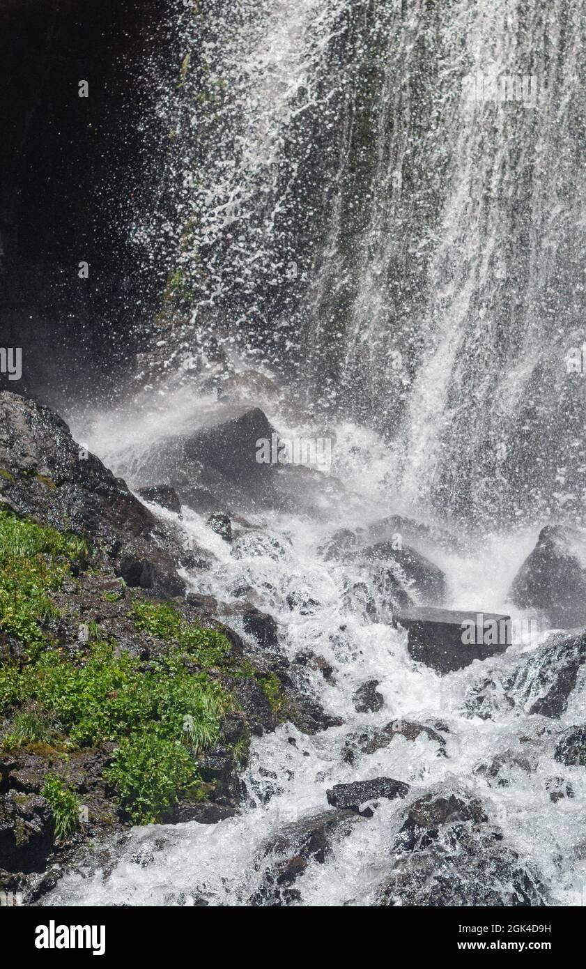 A beautiful waterfall in the mountains. Fresh water flows down from the ...