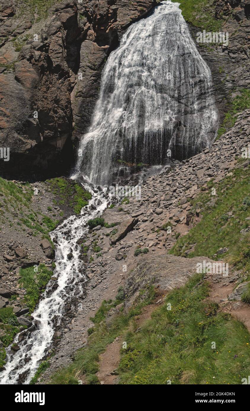 A beautiful waterfall in the mountains. Fresh water flows down from the ...