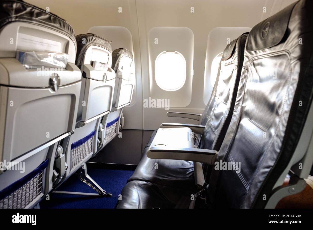 Seat row in an airplane Stock Photo - Alamy