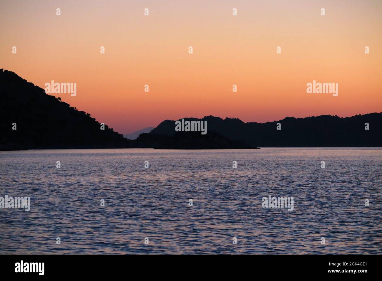 sunset behind mountain Stock Photo - Alamy