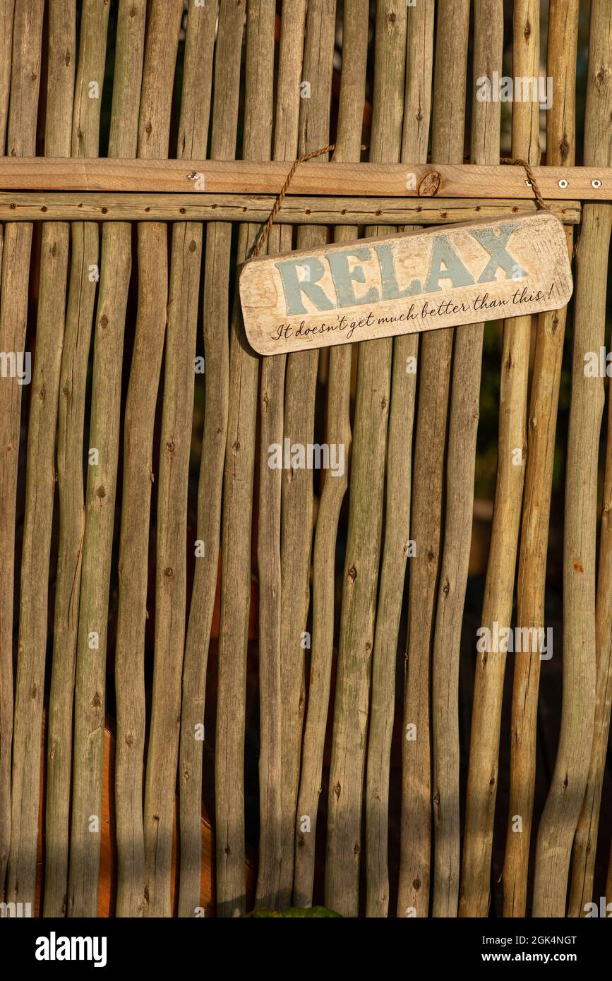 wooden stick fence with relax sign Stock Photo - Alamy