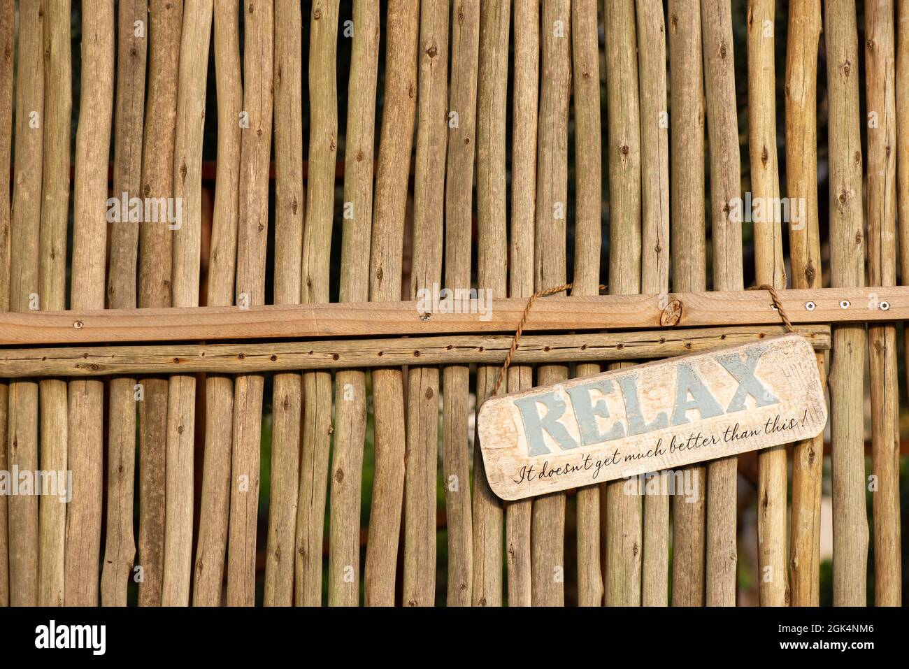wooden stick fence with relax sign Stock Photo - Alamy