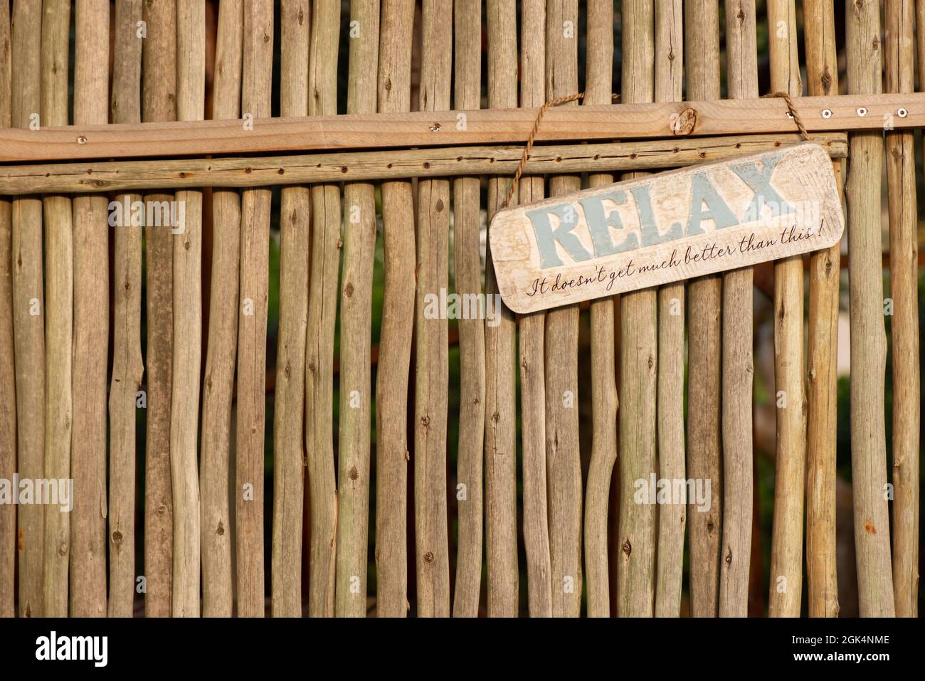 wooden stick fence with relax sign Stock Photo - Alamy