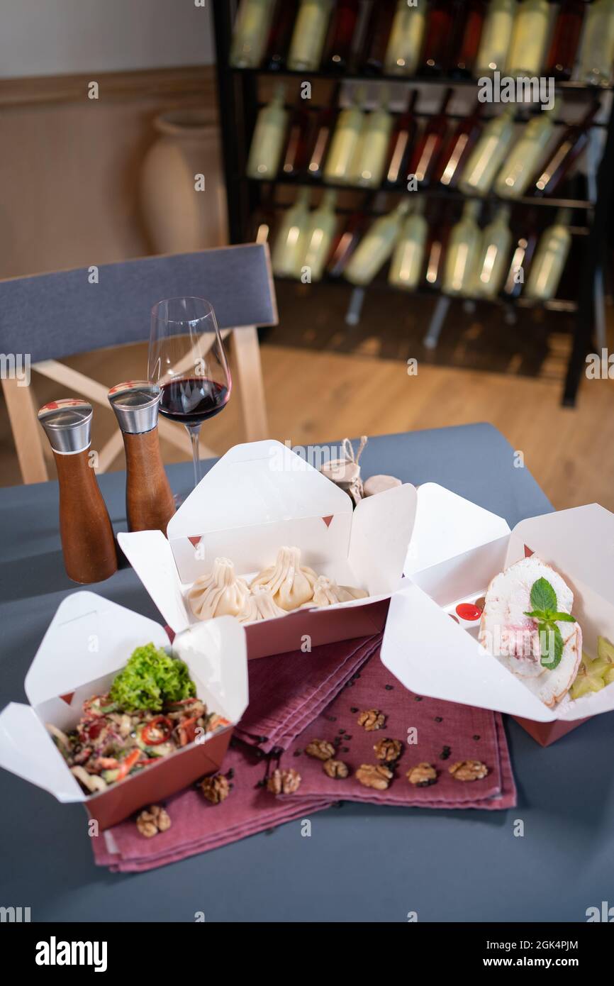 closeup of kraft paper food containers with meal on cafe table for ...