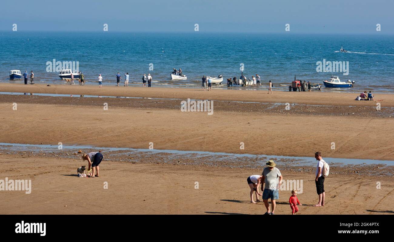 Fishing boats at Filey Beach, North Yorkshire east coast, busy with ...
