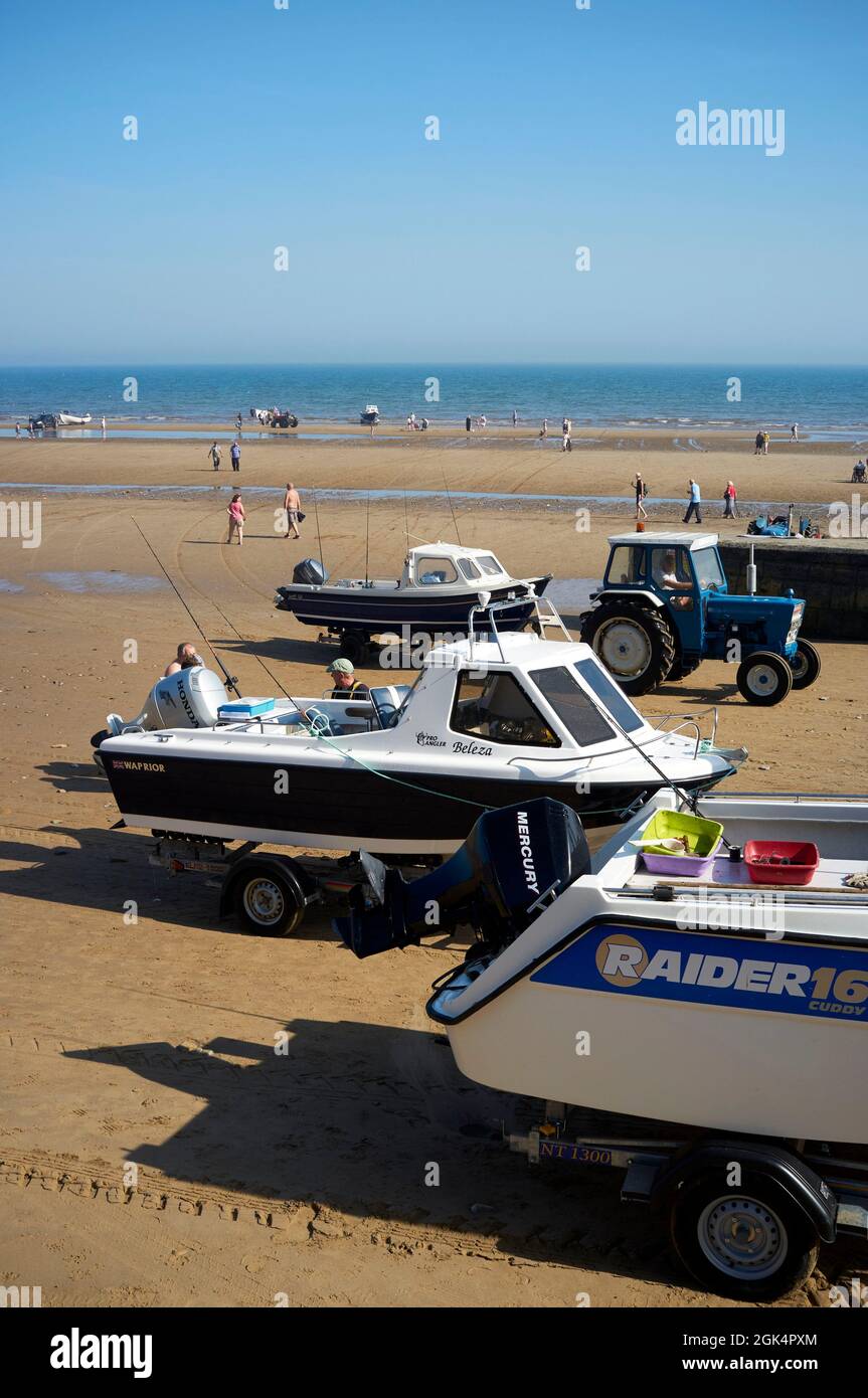 Fishing boats at Filey Beach, North Yorkshire east coast, busy with ...