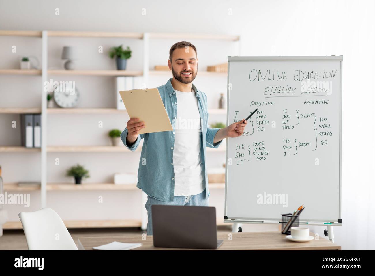Friendly male teacher giving online English class, explaining grammar ...