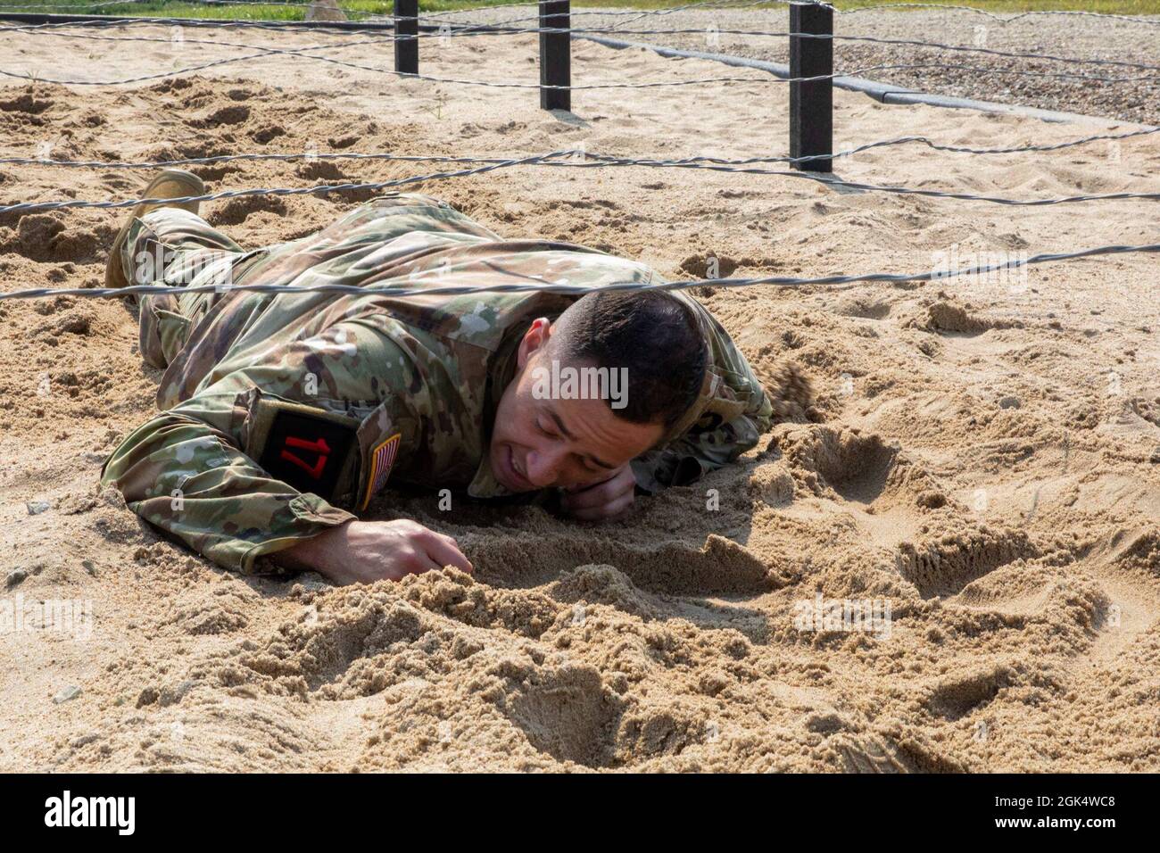 Spc. Daniel Olmedia, an XVIII CORPS Soldier, attacks the low crawl ...