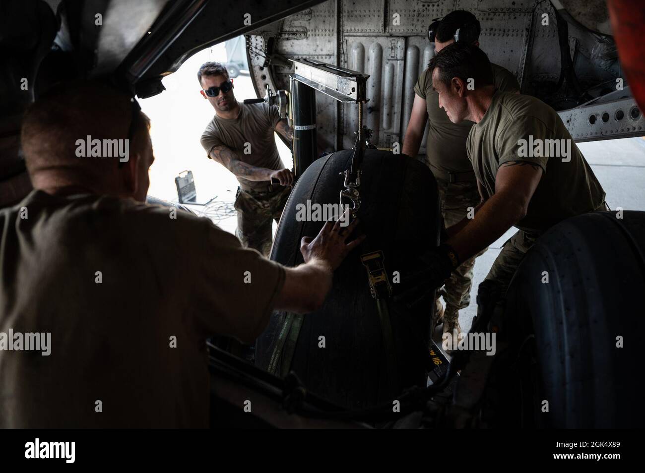 Airmen assigned to the 911th Maintenance Group change a landing gear ...