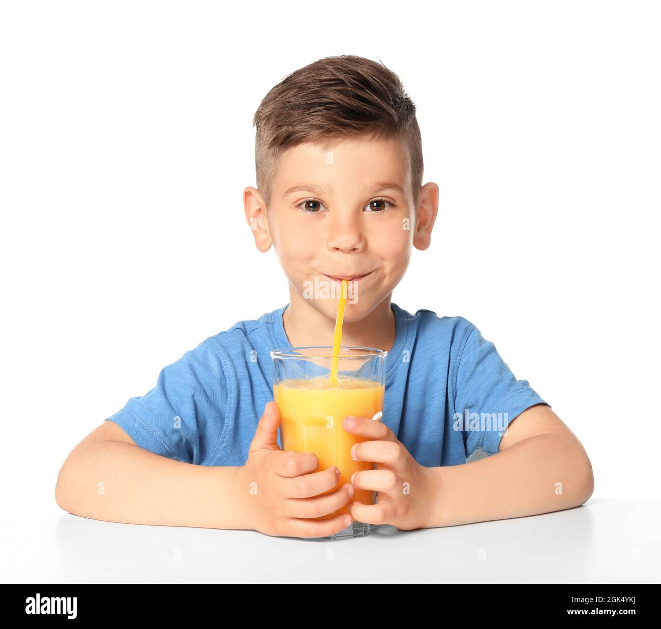 Cute little boy drinking juice on white background Stock Photo - Alamy