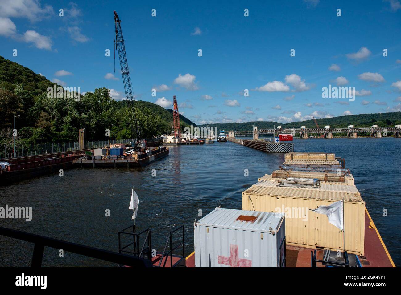 A towboat captain for the Medium Capacity Fleet steers a barge with ...