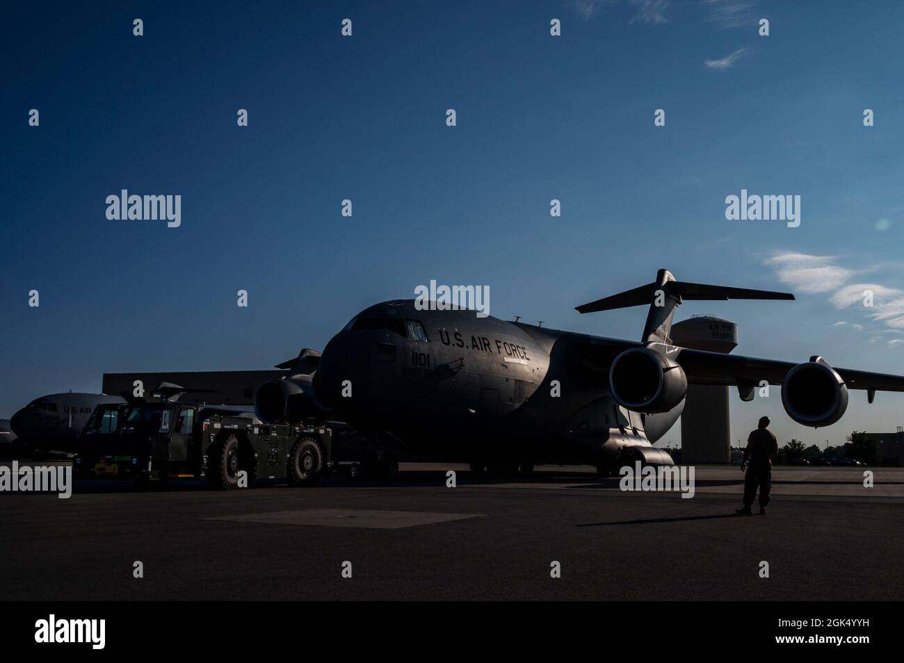Airmen assigned to the 911th Maintenance Group prepare to tow a C-17 ...