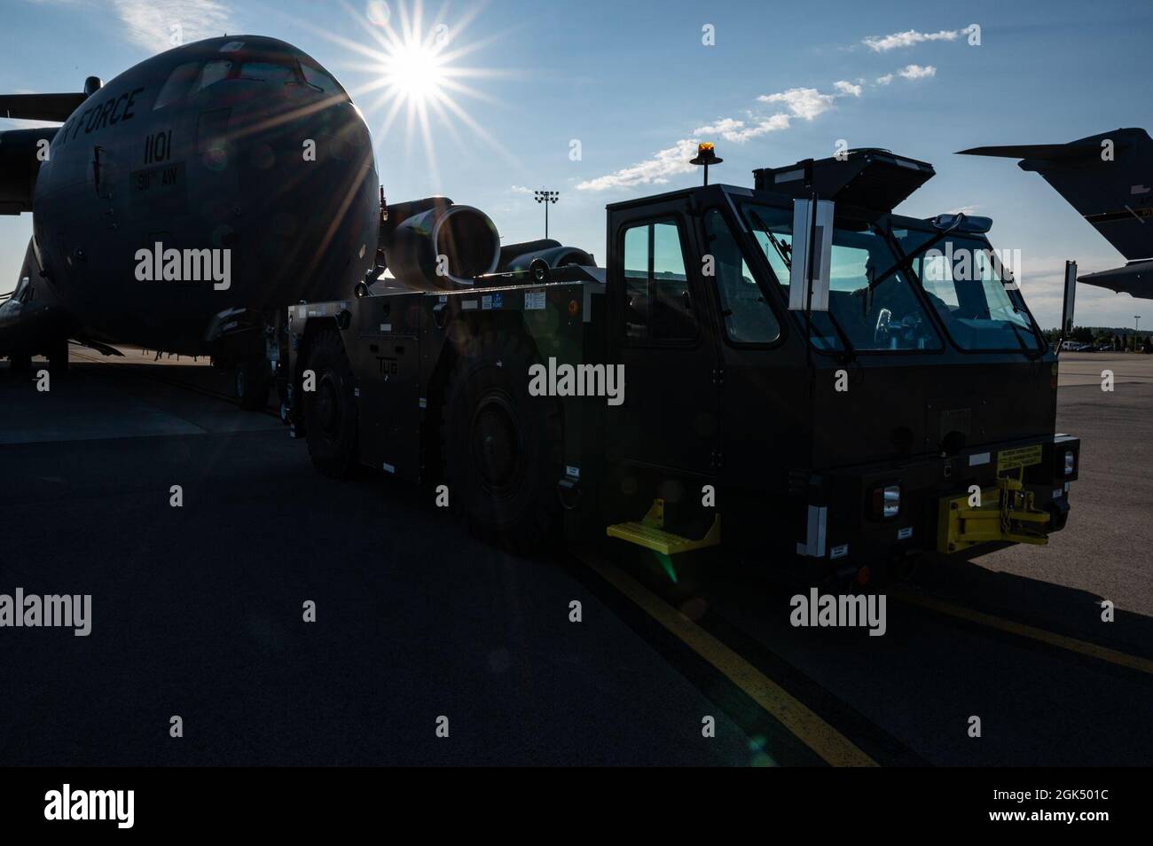 Airmen assigned to the 911th Maintenance Group prepare to tow a C-17 ...